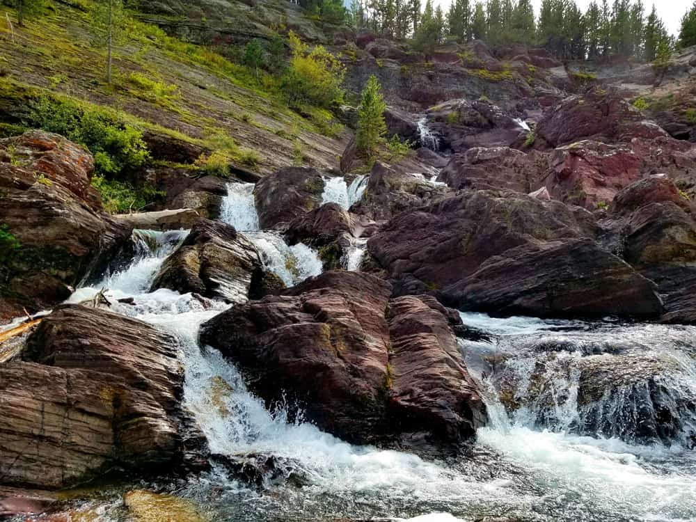 RedRock Falls Hike near Many Glacier Hotel - Fit Living Lifestyle